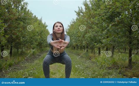 Professional Female Athlete Training Outdoors Doing Jumping Squats To