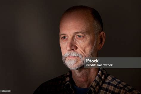 Scruffy Looking Senior Adult Man Staring Vacantly Into The Distance