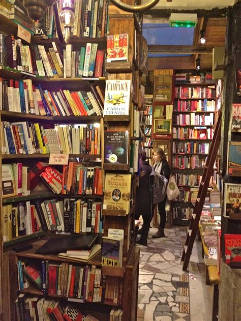 People Are Walking Through A Book Store Filled With Books