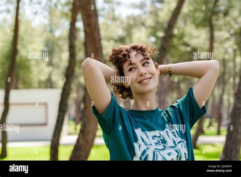 Young Redhead Woman Wearing Green T Shirt Standing On City Park