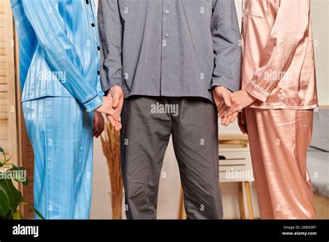 Polygamy Concept Cropped View Of Man Holding Hands With Women At Home