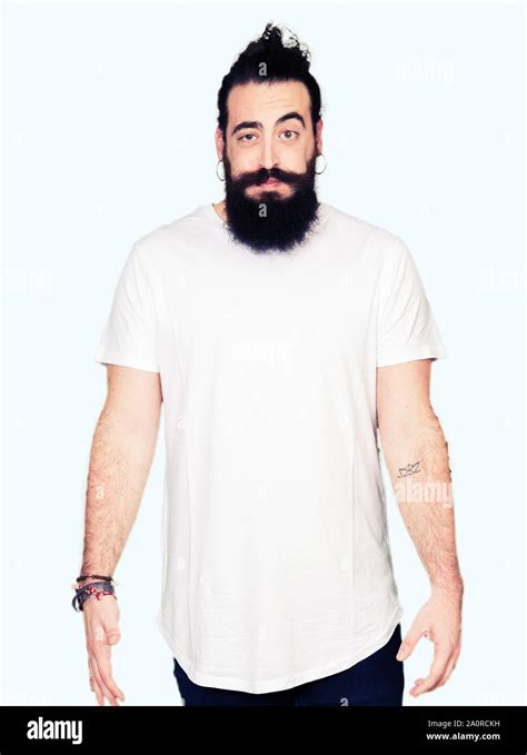 Young Hipster Man With Long Hair And Beard Wearing Casual White T Shirt