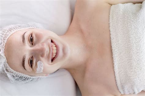 A Beautician Applied A Drop Of Cream To A Young Womanand X27 S Face Skin