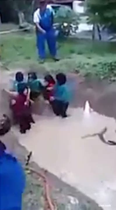 shocking moment terrified schoolgirls are forced into pond