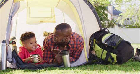 Happy African American Father And His Son Embracing In Garden Stock