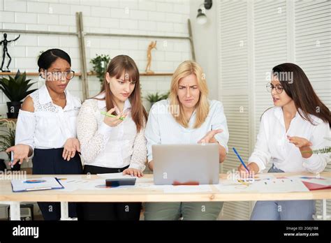 Serious Female Multiracial Team Solving Problem Together Diverse