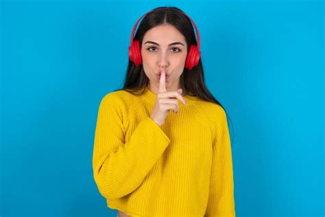 Premium Photo Woman Making Hush Gesture With Finger On Her Lips