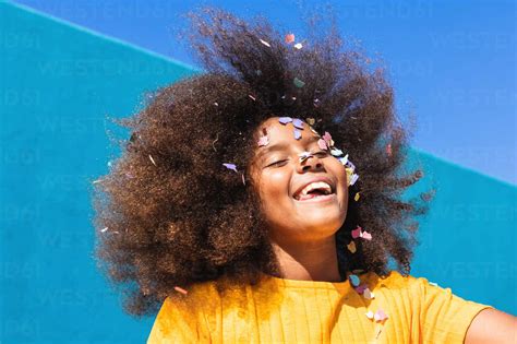 Low Angle Of Happy Carefree Teen African American Girl With Long Curly