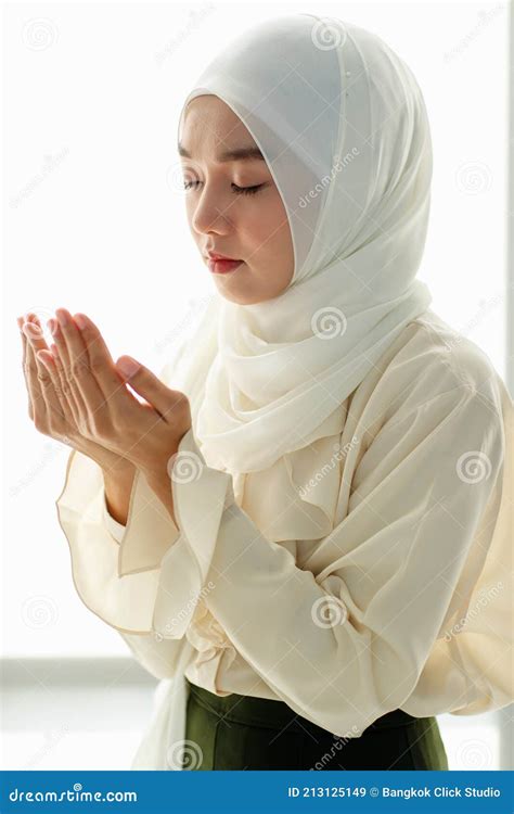 Young And Beautiful Asian Muslim Woman Praying With Respect And Calm
