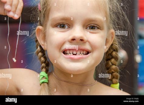 Six Year Old Girl Holding Her Milk Had Fallen Lower Front Teeth On A