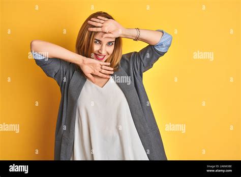 Redhead Caucasian Business Woman Over Yellow Isolated Background