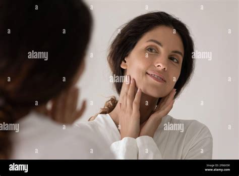 Close Up Happy Beautiful Woman Touching Face Looking In Mirror Stock