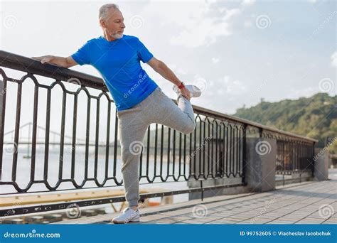 Senior Man Stretching Leg Muscles Before Morning Run Stock Image