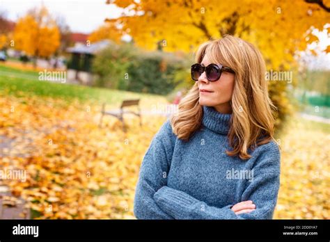 Portrait Shot Of Confident Mature Woman Wearing Turtleneck Sweater And