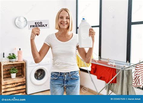 Young Blonde Woman Holding Detergent Bottle And Eco Friendly Banner At