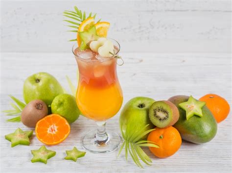 Premium Photo Summer Cocktail With Various Tropical Fruits Around