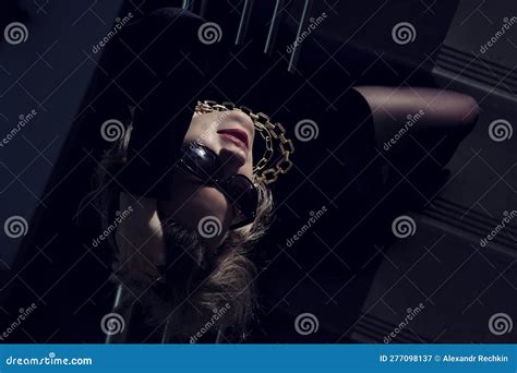 Blonde Total Black In A Short Dress Stockings Is Standing On The