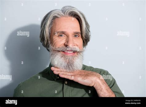Portrait Of Attractive Groomed Cheerful Grey Haired Man Touching