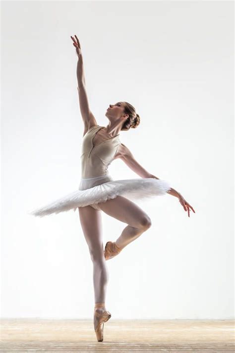 A Woman In White Is Dancing On The Floor