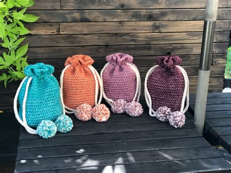 Crochet Drawstring Bag Pattern With Pom Poms Knitcroaddict