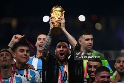 Argentinas Forward Lionel Messi Lifts The World Cup Trophy During