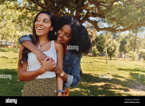 Young African American Woman Hugging Her Friend Showing Love And Care