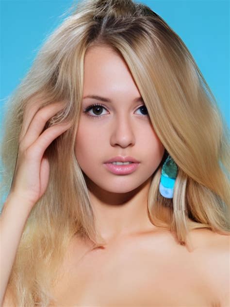 A Woman With Long Blonde Hair Holding A Toothbrush In Her Right Hand