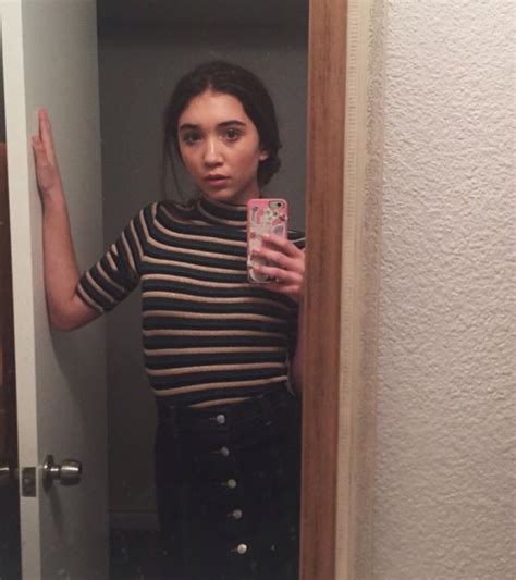 A Woman Is Taking A Selfie In The Mirror