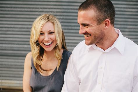 A Beautiful Couple In Love Standing In An Urban Warehouse Area By