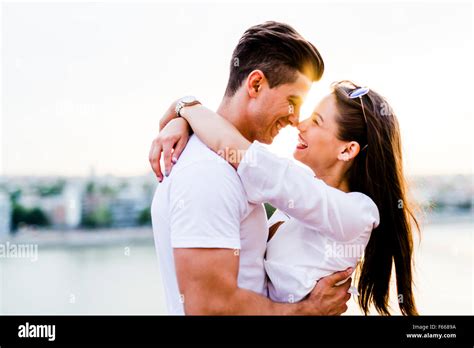 Young Romantic Couple Hugging And About To Kiss In Beautiful Sunset