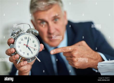 The Clocks Ticking Portrait Of A Mature Businessman Gesturing Toward A