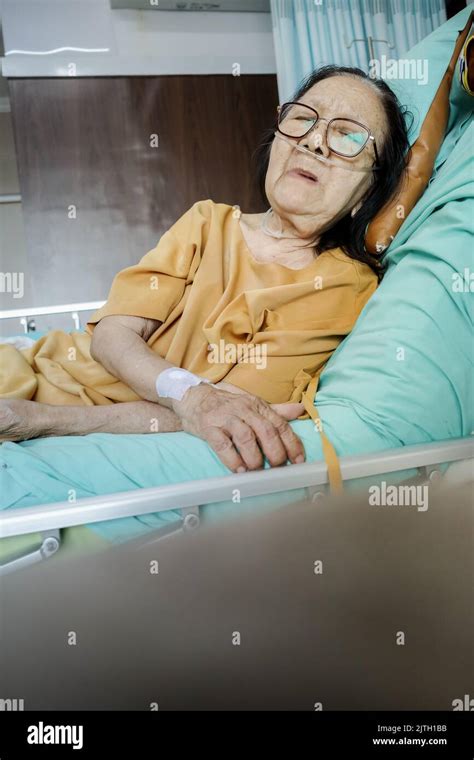 Sick Southeast Asian Female Senior Patient With Respiratory Disorder