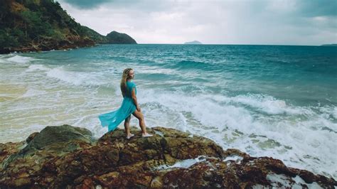 Premium Photo Sexy Hot Woman Meditates Relaxes On A Rock Reef Hill In