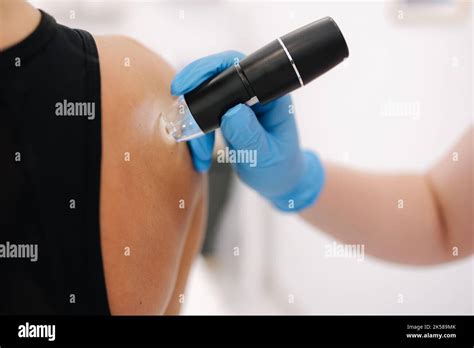 Doctor And Female Client In Dermatology Clinic Macro Photo Of