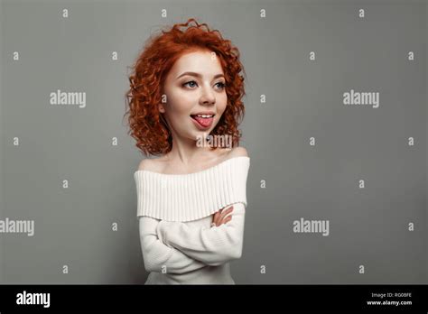 Young Cute Redhead Curly Haired Girl Shows Her Tongue Teasing On The