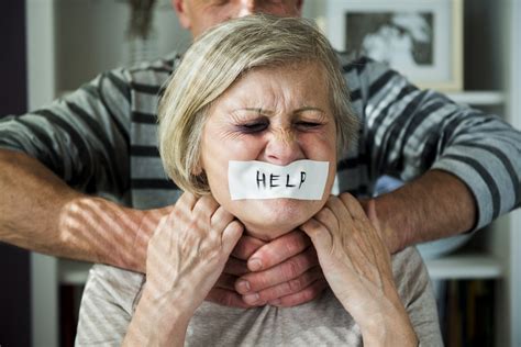 Portrait Of Woman Victim Of Domestic Violence Man Abusing Senior Woman