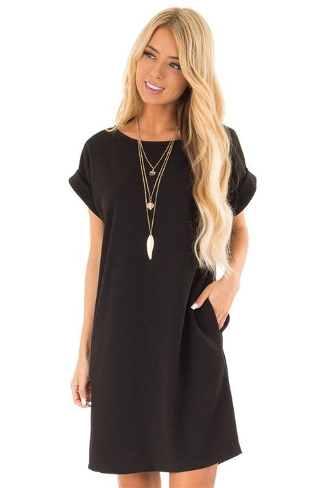 Black Shift Dress With Short Cuffed Sleeves And Pockets Front Close Up