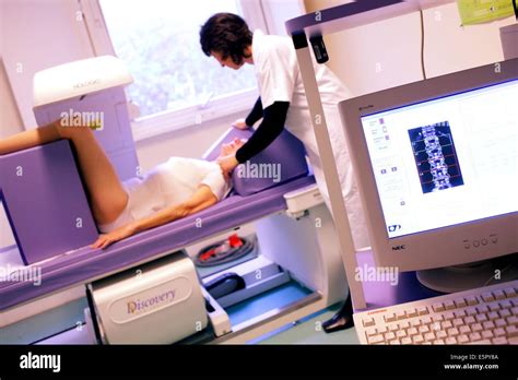 A Doctor Uses A Bone Densitometer To Measure The Optical Density Of The