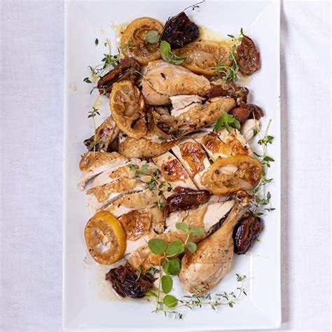 A White Plate Topped With Chicken And Veggies