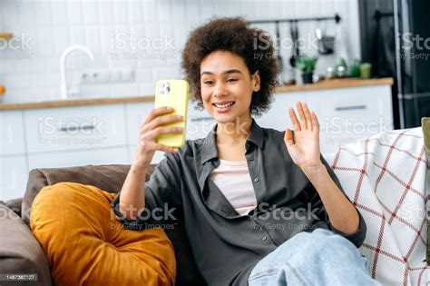 Modern Positive Beautiful Curly Haired African American Girl Talking On