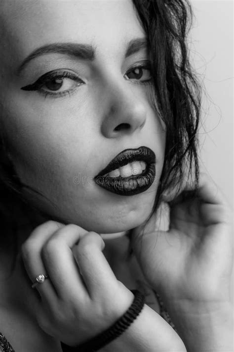 Black And White Portrait Of A Beautiful Young Woman With Black Lipstick