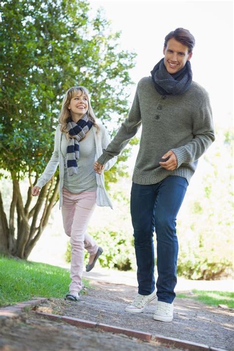 Cute Couple Walking Hand In Hand In The Park Stock Image Image Of