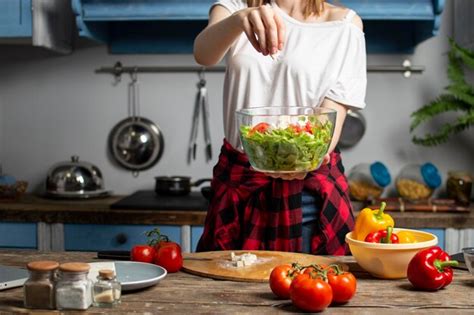 Premium Photo Young Girl Prepares A Vegetarian Salad In The Kitchen