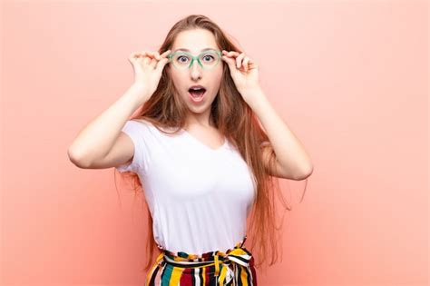 Premium Photo Feeling Shocked Amazed And Surprised Holding Glasses