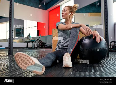Woman Doing Exercises With Fitball In Fitness Gym Class Engaging Core
