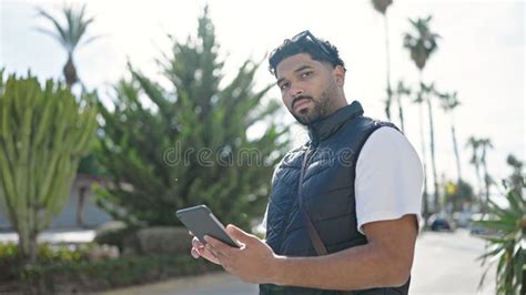 African American Man Smiling Confident Using Touchpad At Park Stock