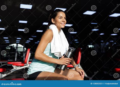 Back View Of Concentrated Sports Woman Doing Exercise With Dumbbells