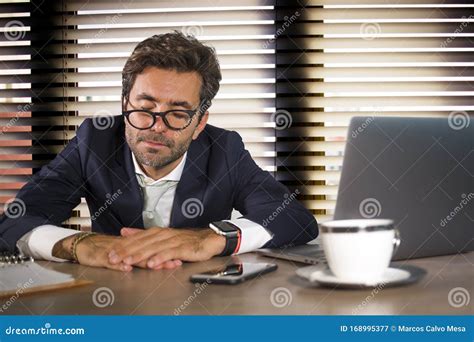 Depressed And Stressed Attractive Hispanic Businessman In Suit And Tie