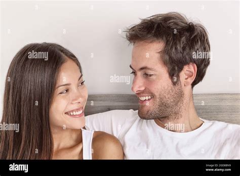 Happy Couple In Love Smiling At Each Other Looking Into Their Eyes
