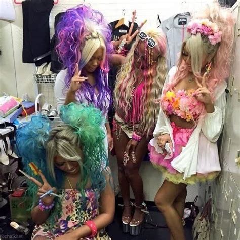 Four Women Dressed Up In Wigs And Costumes